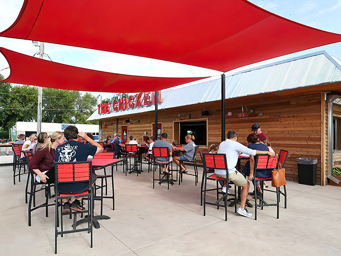 The rustic wooden exterior with those eye-catching red shade sails isn't just inviting&mdash;it's practically shouting "Come get some chicken that'll change your life!"