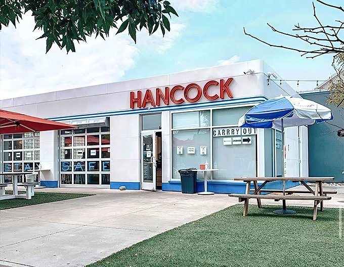 That neon sign isn't just announcing a restaurant&mdash;it's broadcasting a siren call to fried chicken lovers across Grand Rapids. The retro-modern exterior promises delicious things within.