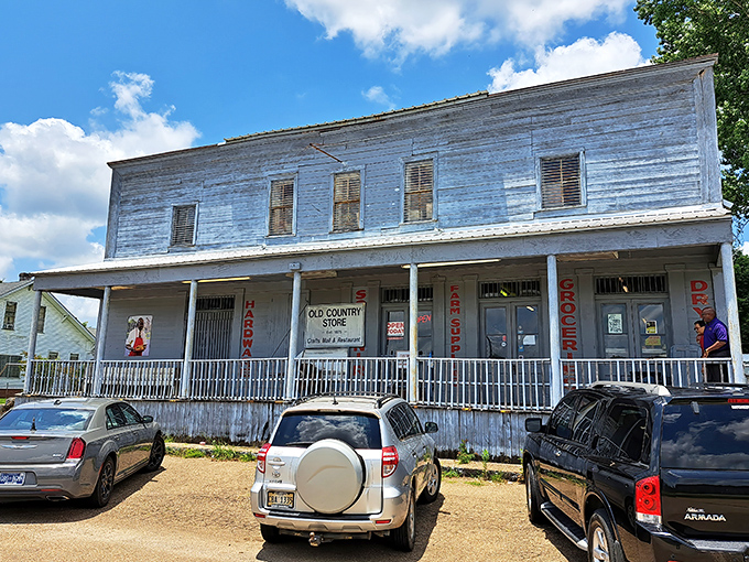 The weathered clapboard exterior of The Old Country Store stands as a time capsule from the 1800s, beckoning hungry travelers with rustic charm.