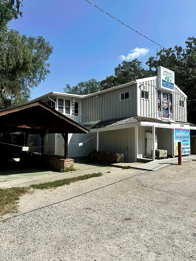 The bright turquoise exterior of Alpine Inn stands like a beacon of comfort food in northeast Omaha, promising fried chicken worth the journey.