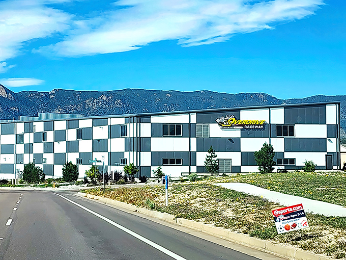 The checkered exterior of Overdrive Raceway stands against Colorado's mountain backdrop like a racing flag waving you toward adventure.