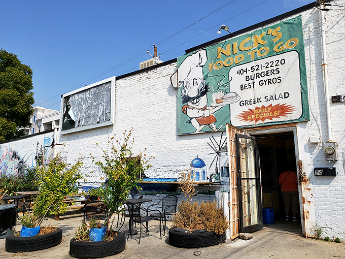 The unassuming white brick fa&ccedil;ade of Nick's Food To Go stands like a culinary lighthouse in Atlanta's urban landscape, beckoning hungry souls with its vintage sign.