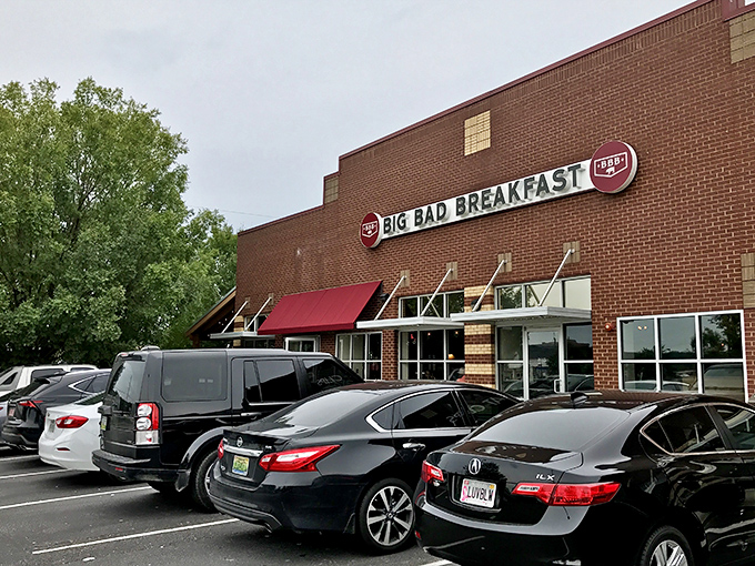 The brick fortress of breakfast dreams announces itself with that bold red awning. Big Bad Breakfast isn't whispering its presence&mdash;it's shouting delicious promises.