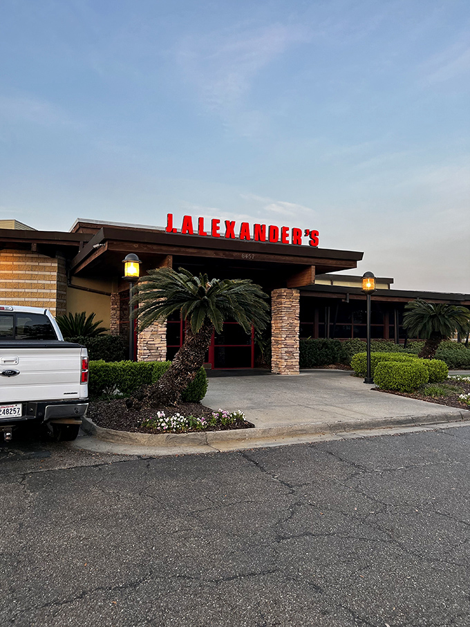 The iconic red lettering against stone and wood welcomes you like an old friend. Palm trees add that distinctive Louisiana touch to J. Alexander's inviting entrance.