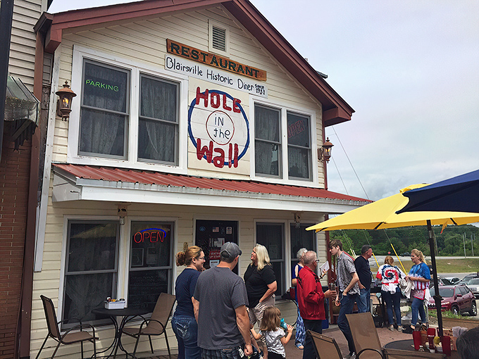 The unassuming exterior of Hole In The Wall beckons like an old friend, promising comfort and satisfaction behind that screen door.