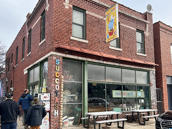 The iconic brick facade of Succotash welcomes hungry souls with its vintage vertical signage and promise of comfort food extraordinaire.