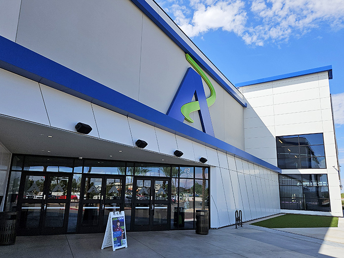 The sleek exterior of Andretti Indoor Karting beckons speed enthusiasts with its modern design and that iconic blue "A" logo&mdash;racing paradise awaits inside.