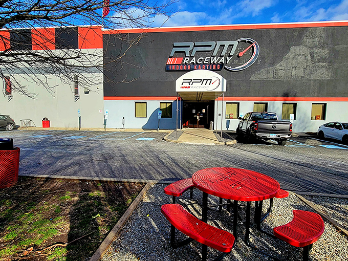 The red and black exterior of RPM Raceway stands like a temple to speed, promising adrenaline rushes inside its unassuming industrial shell.
