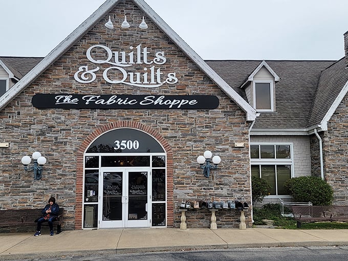 The stone facade of Quilts & Quilts stands like a crafting castle in Branson, beckoning fabric enthusiasts with promises of textile treasures within. 