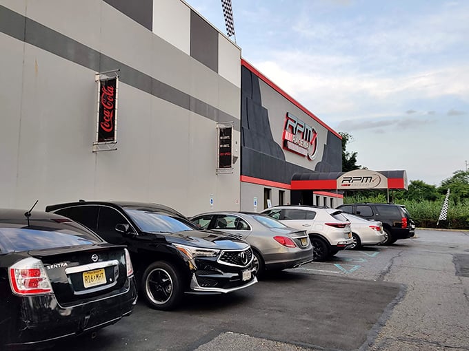 The red and black exterior of RPM Raceway stands like a temple to speed, promising adrenaline rushes inside its unassuming industrial shell.