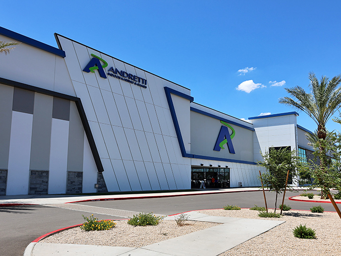 The sleek exterior of Andretti Indoor Karting beckons speed enthusiasts with its modern design and that iconic blue "A" logo—racing paradise awaits inside.