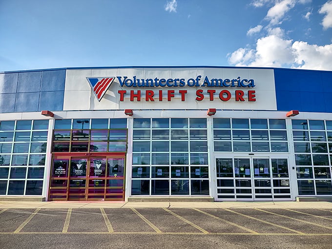 The blue and white exterior stands like a retail fortress of possibility, promising treasure hunts behind those bold red doors.