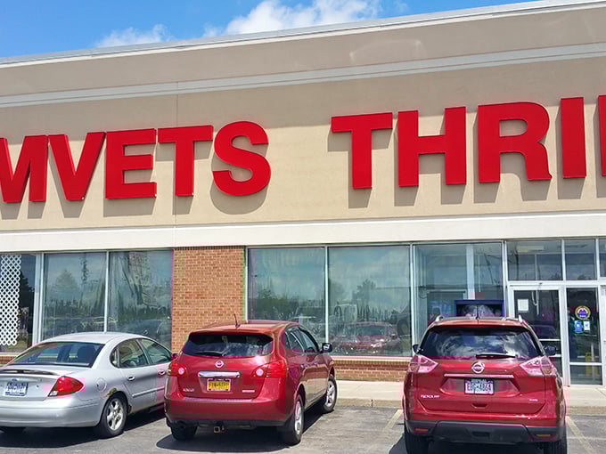 The bright red letters of AMVETS Thrift call to bargain hunters like a beacon, promising treasures waiting just beyond those doors.
