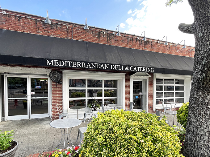 A humble brick storefront that holds more culinary treasures than your grandmother's secret recipe box. Mediterranean Deli's exterior promises authentic flavors within.