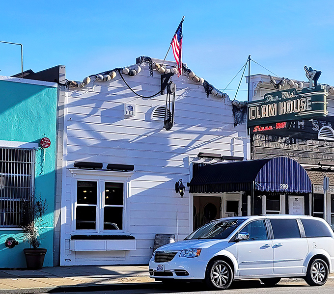 Twilight transforms this 1861 seafood sanctuary into a maritime mirage. The vintage neon sign beckons hungry travelers like a lighthouse for the famished.