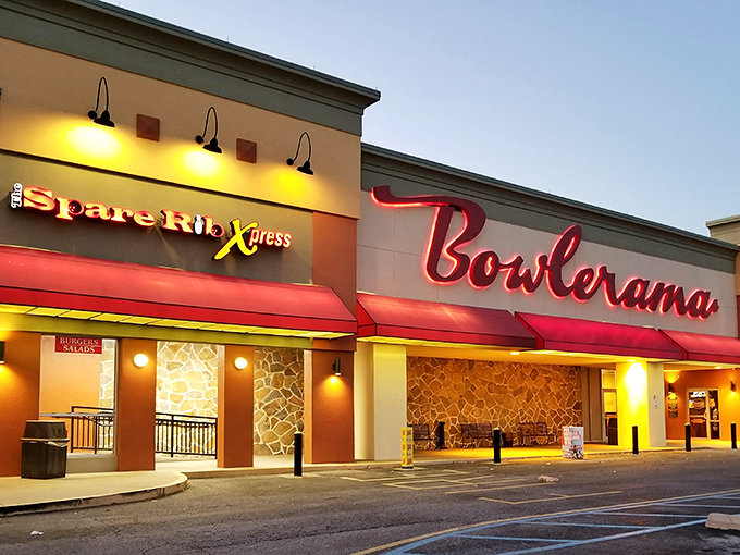 That iconic red neon sign glowing against the dusk sky isn't just advertising bowling&mdash;it's broadcasting a portal back to simpler times.