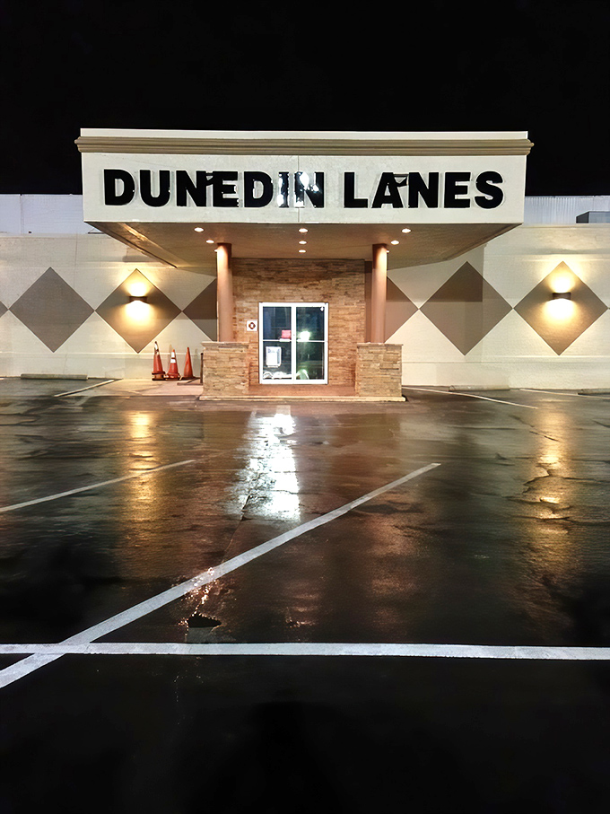 The classic neon-lit entrance to Dunedin Lanes beckons like a portal to simpler times when entertainment didn't require a Wi-Fi password.