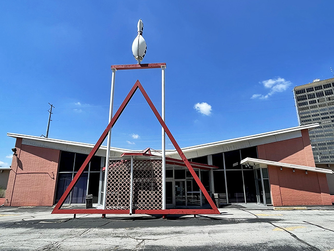 The iconic A-frame entrance of Tropicana Lanes stands like a mid-century time portal, complete with that space-age bowling pin perched proudly on top.