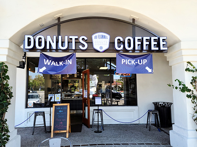 The unassuming storefront that houses donut greatness. Blue banners and simple signage &ndash; no flash, all substance.