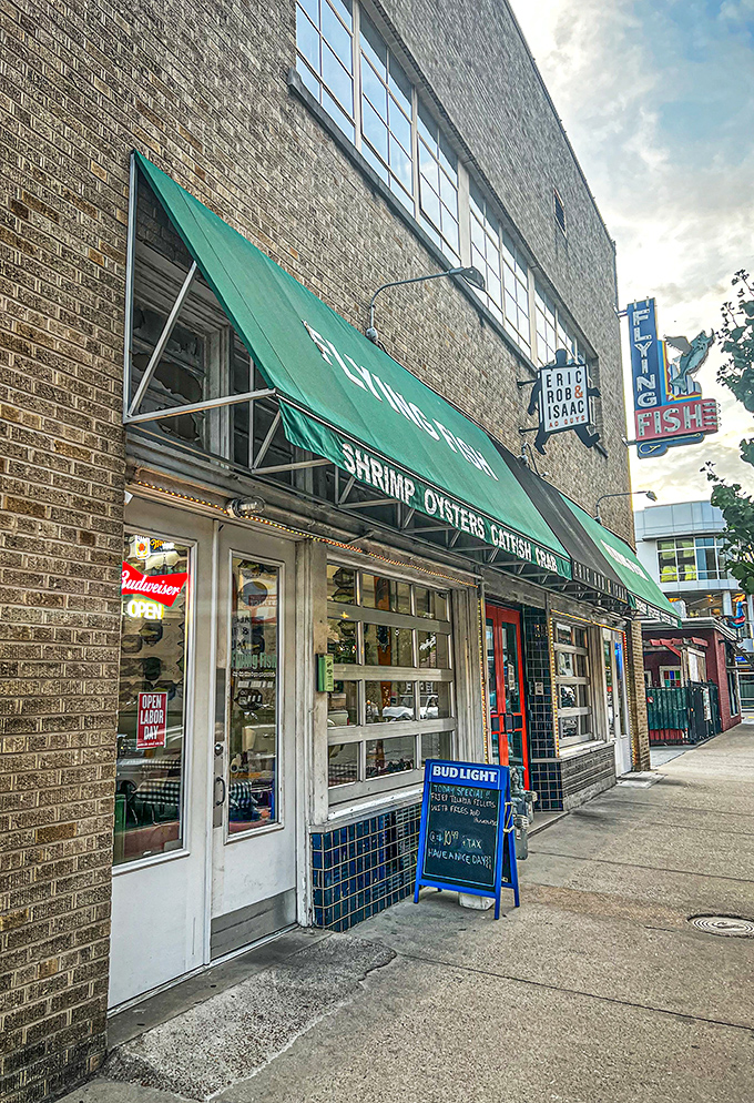 The green awning beckons like a seafood siren song. Flying Fish's no-nonsense exterior promises what fancy restaurants often forget: incredible food without the fuss.