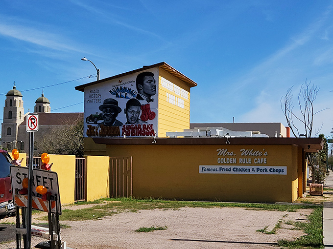 The unassuming yellow exterior of Mrs. White's Golden Rule Cafe stands like a beacon of culinary promise, boldly advertising its famous chicken fried steak.