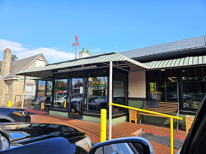 The unassuming exterior of Benson's Grill stands as a beacon to breakfast lovers. That parking sign might as well say "This way to happiness."