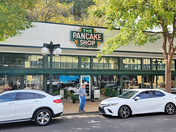 The iconic green sign beckons like a breakfast lighthouse on Hot Springs' Central Avenue, promising pancake perfection to early risers and brunch enthusiasts alike.