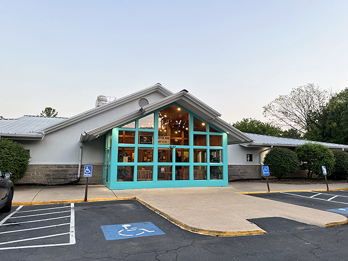 The turquoise-framed entrance of The Catfish Hole stands like a beacon of Southern comfort food, promising delicious treasures within its unassuming exterior.