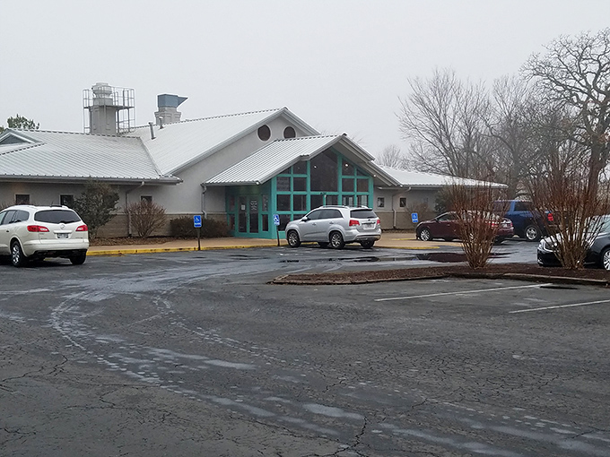 The turquoise-framed entrance of The Catfish Hole stands like a beacon of Southern comfort food, promising delicious treasures within its unassuming exterior.