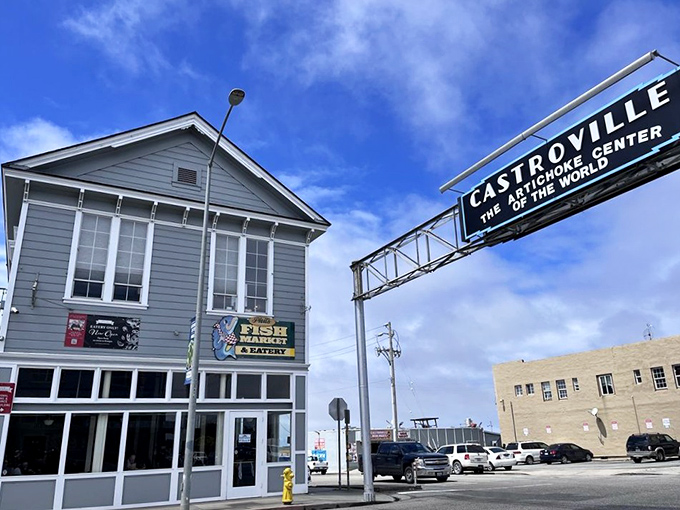 The unassuming exterior of Phil's Fish Market stands beneath Castroville's iconic sign, proving that culinary treasures often hide in plain sight.