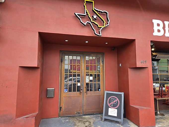 The crimson facade of Bludso's Bar & Que stands like a beacon of barbecue hope on La Brea, promising smoky salvation to meat lovers everywhere.