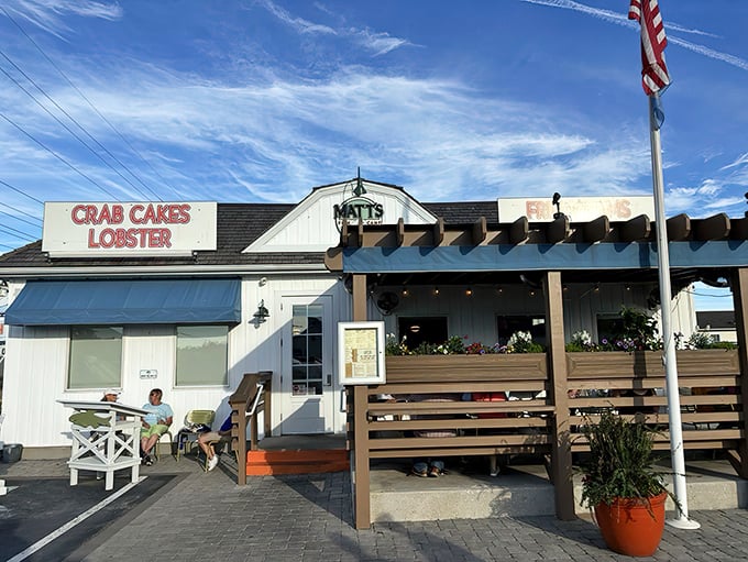 The coastal charm offensive begins! Matt's Fish Camp's white clapboard exterior with its "CRAB CAKES LOBSTER" sign is Delaware's seafood siren call to hungry travelers.