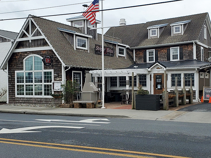 Striper Bites' cedar-shingled exterior feels like a coastal hug, with its welcoming porch and lush greenery inviting you to kick back and stay awhile.