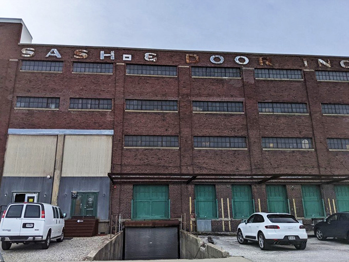 The imposing brick exterior of Midland Arts & Antiques Market still proudly displays its "SASH & DOOR" industrial heritage, promising treasures within those weathered walls.