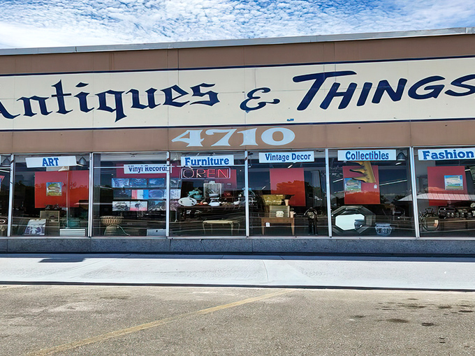 The storefront beckons with promises of treasures within, its blue lettering against beige like a desert sky invitation to explore.
