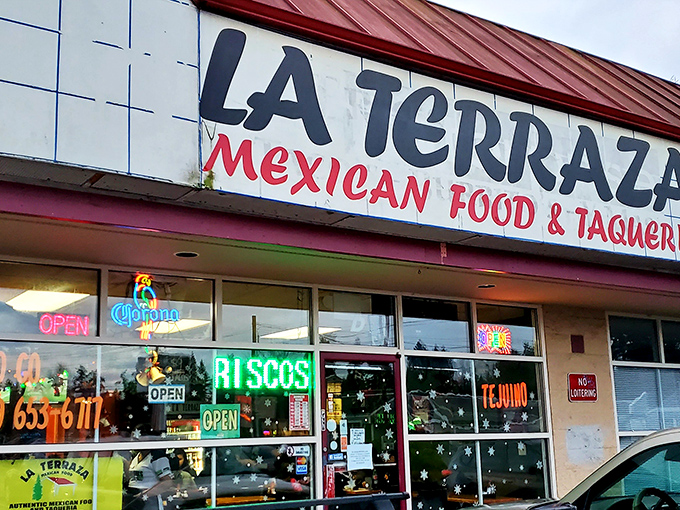 La Terraza's vibrant storefront beckons with neon signs promising authentic Mexican flavors. The "OPEN" sign might as well say "Passport to Mexico."