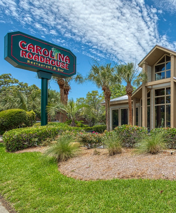 The welcoming fa&ccedil;ade of Carolina Roadhouse stands ready to transform your ordinary dinner into a memorable feast under Carolina's blue skies.