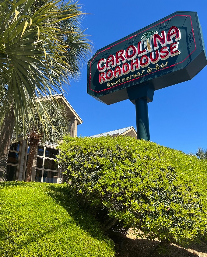 The welcoming fa&ccedil;ade of Carolina Roadhouse stands ready to transform your ordinary dinner into a memorable feast under Carolina's blue skies.