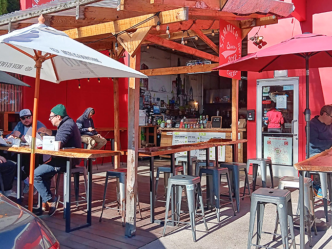 The vibrant red exterior of Sammich PDX beckons like a siren call to sandwich lovers. Outdoor seating perfect for Portland's precious sunny days.