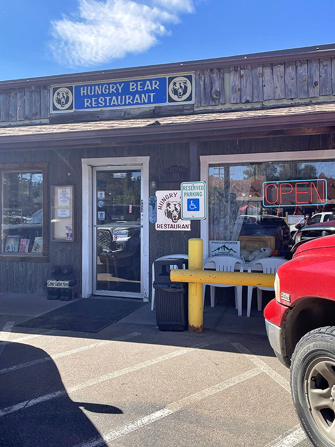 The rustic wooden exterior of Hungry Bear Restaurant stands proudly against Colorado's blue sky, promising comfort food that matches the mountain charm.