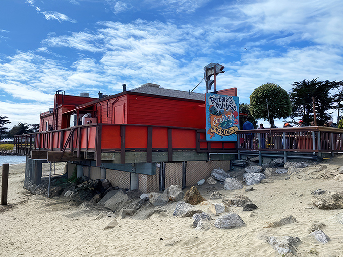 The little red seafood shack that could! Barbara's Fishtrap stands proudly against the Half Moon Bay skyline, promising maritime delights within its humble walls.