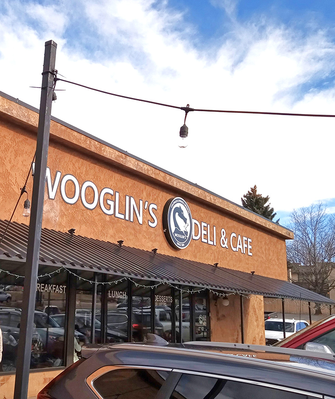 The stucco facade of Wooglin's Deli & Cafe welcomes hungry travelers with its distinctive dragon logo&mdash;a neighborhood landmark that promises comfort in sandwich form.