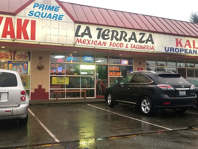 La Terraza's vibrant storefront beckons with neon signs promising authentic Mexican flavors. The "OPEN" sign might as well say "Passport to Mexico."
