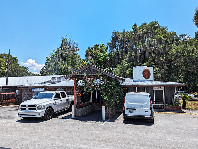The unassuming entrance to culinary paradise. Spanish moss and Florida pines stand guard over this literary landmark that's been serving authentic flavors since 1952.