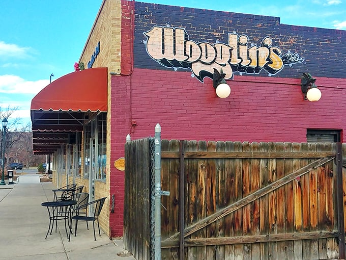 The stucco facade of Wooglin's Deli & Cafe welcomes hungry travelers with its distinctive dragon logo—a neighborhood landmark that promises comfort in sandwich form.