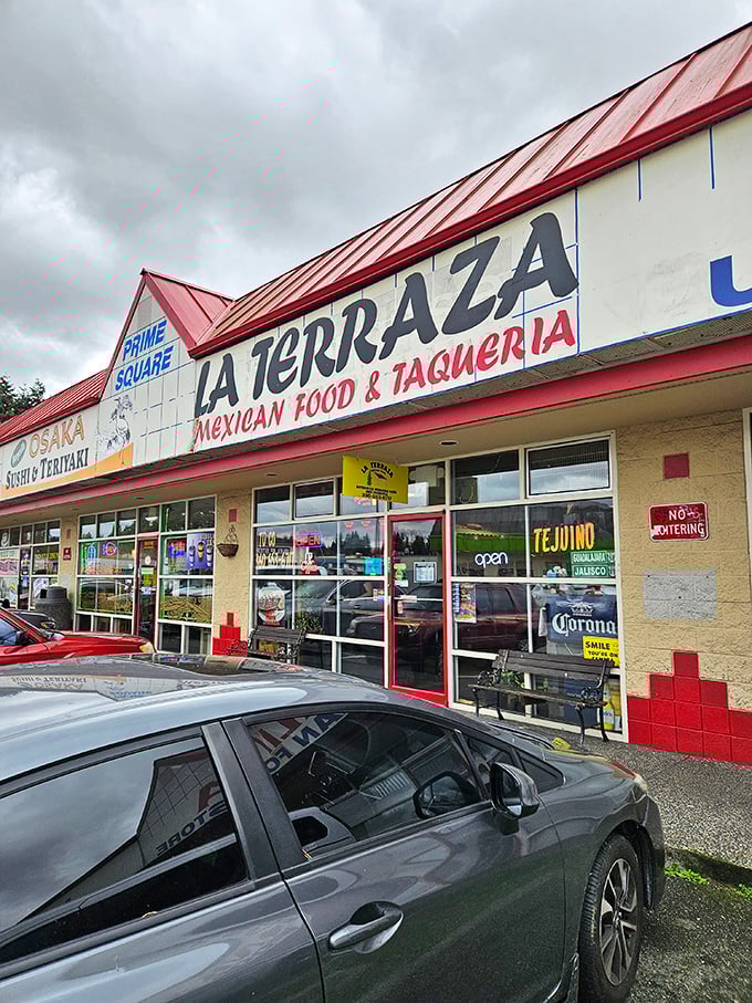 La Terraza's vibrant storefront beckons with neon signs promising authentic Mexican flavors. The "OPEN" sign might as well say "Passport to Mexico."