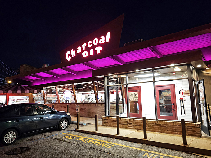 The iconic red neon sign of Charcoal Pit glows like a beacon of burger hope on Concord Pike, promising a time-traveling culinary adventure since 1956.