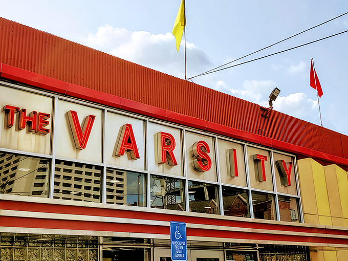 The iconic yellow and red exterior of The Varsity stands like a time capsule of American dining, beckoning hungry travelers with its retro charm.