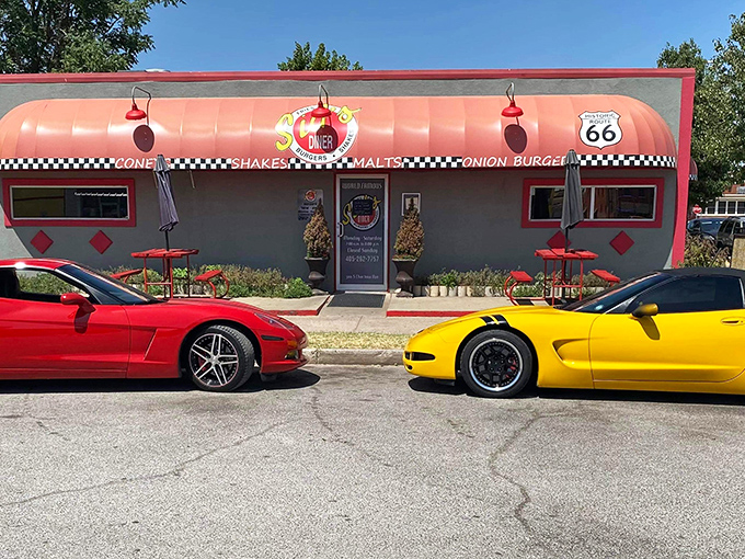 Route 66 nostalgia meets burger paradise at Sid's Diner, where the coral exterior and checkered trim promise a taste of authentic Americana.