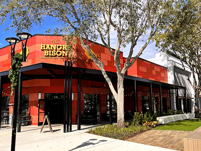 The distinctive red facade of The Hangry Bison stands out in Winter Park like a beacon for burger enthusiasts seeking meaty salvation.